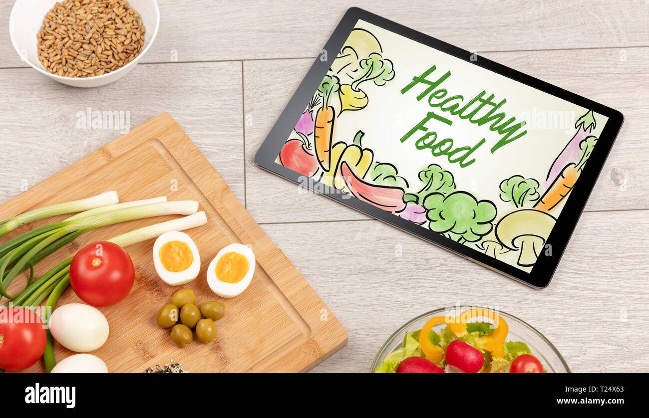Healthy food composition with tablet Stock Photo - Alamy