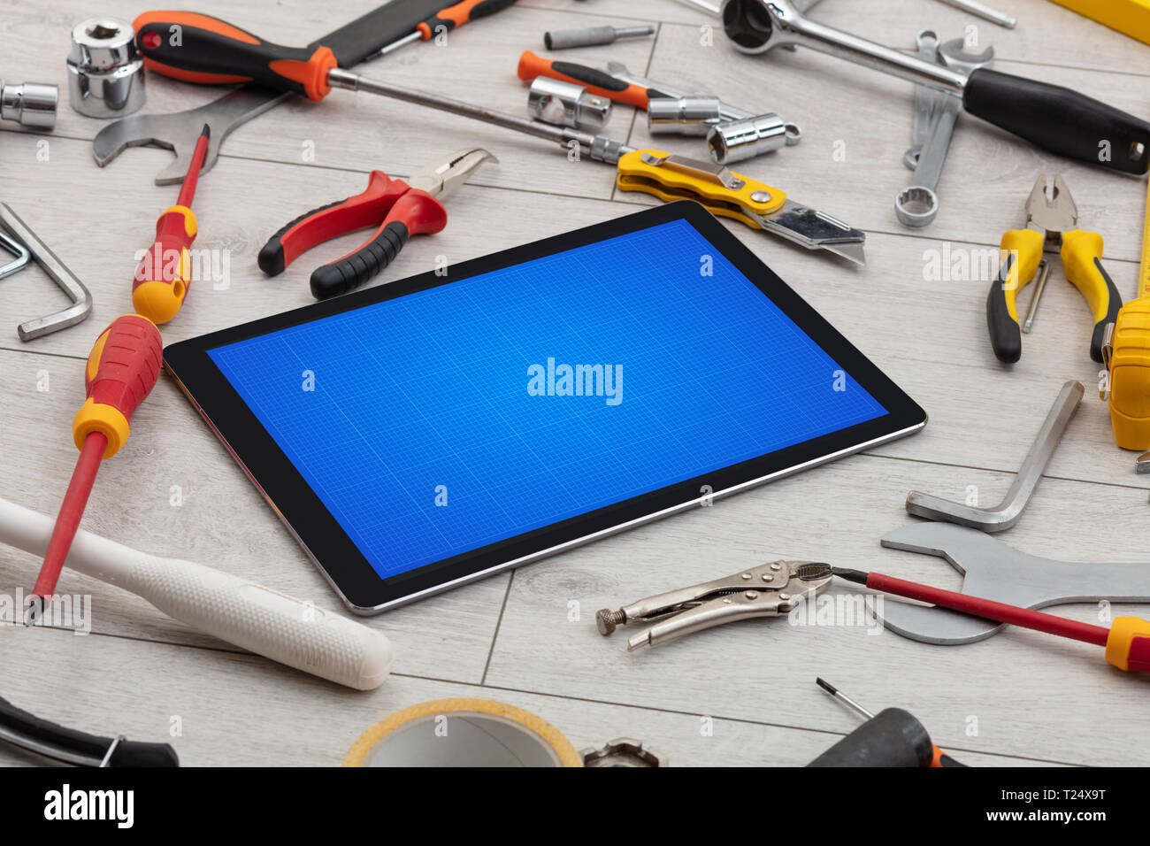 Household tools and tablet with grid screen concept Stock Photo - Alamy