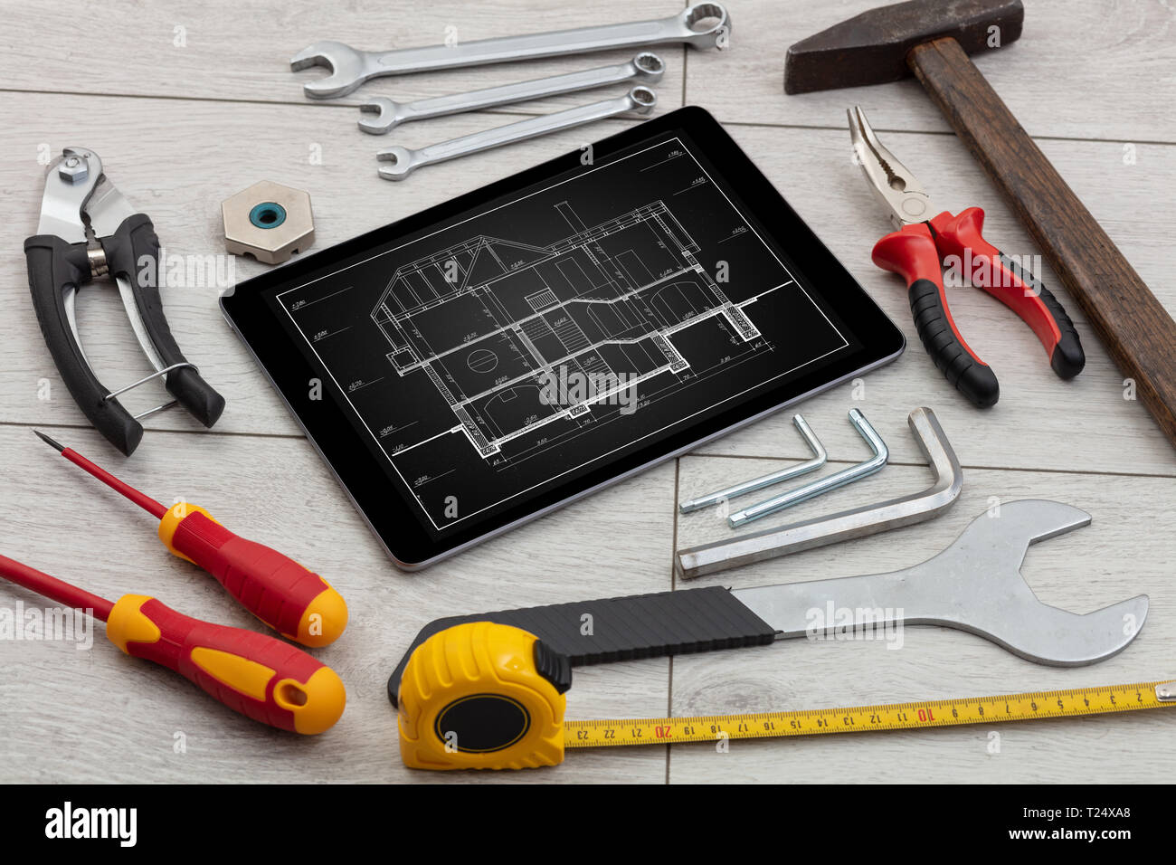 Tablet with construction tools and blueprint concept Stock Photo - Alamy