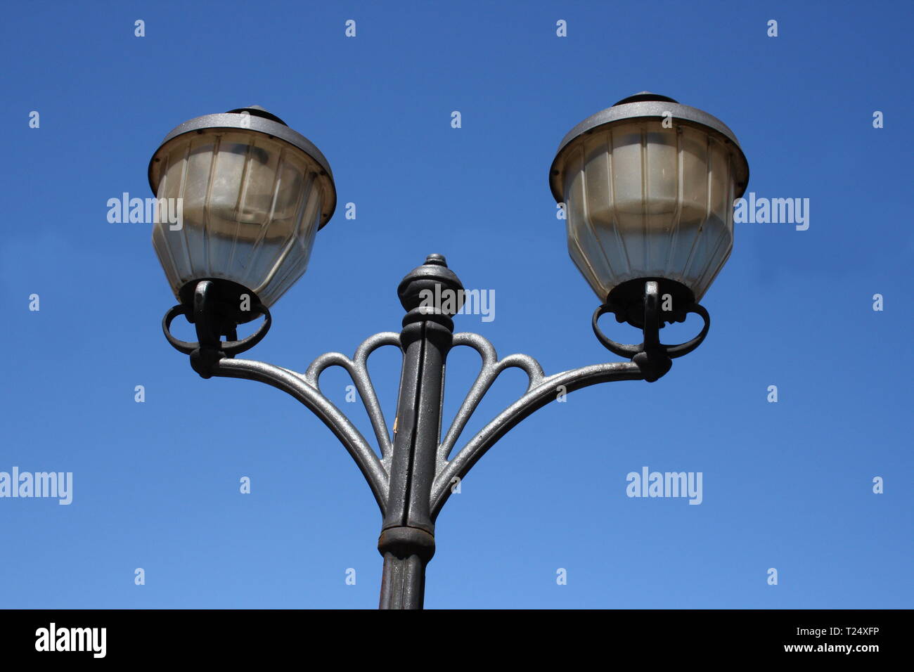 Street light with two lamps, blue sky in the background Stock Photo - Alamy