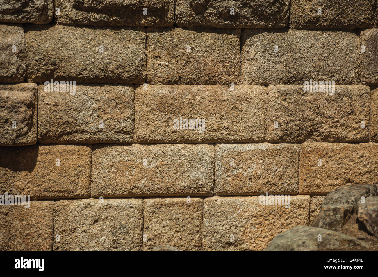 Wall made of large stone bricks forming a charming pattern in the Roman ...