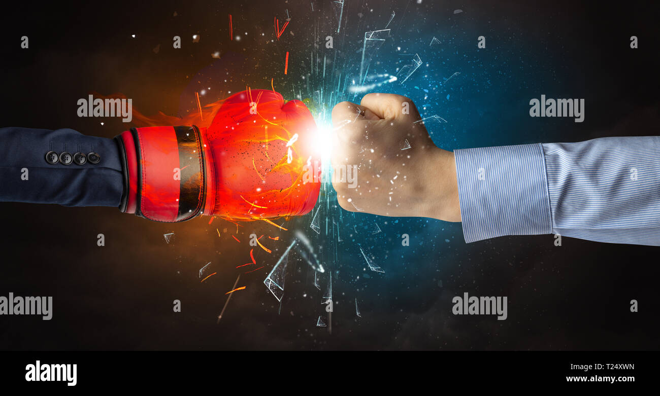 Two hands fighting and breaking glass into small pieces with fire and ...