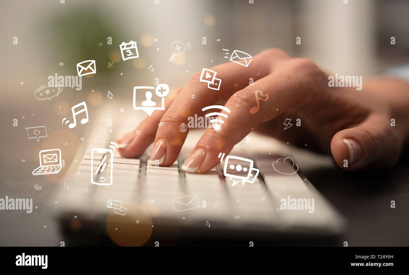 Business woman hand typing on keyboard with drawn application icons ...