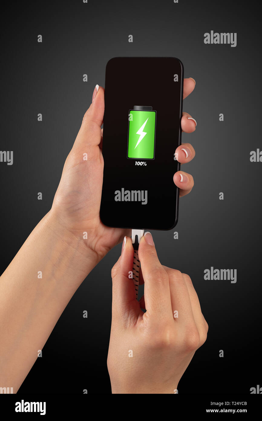 Elegant hand charging cellphone with low battery Stock Photo - Alamy