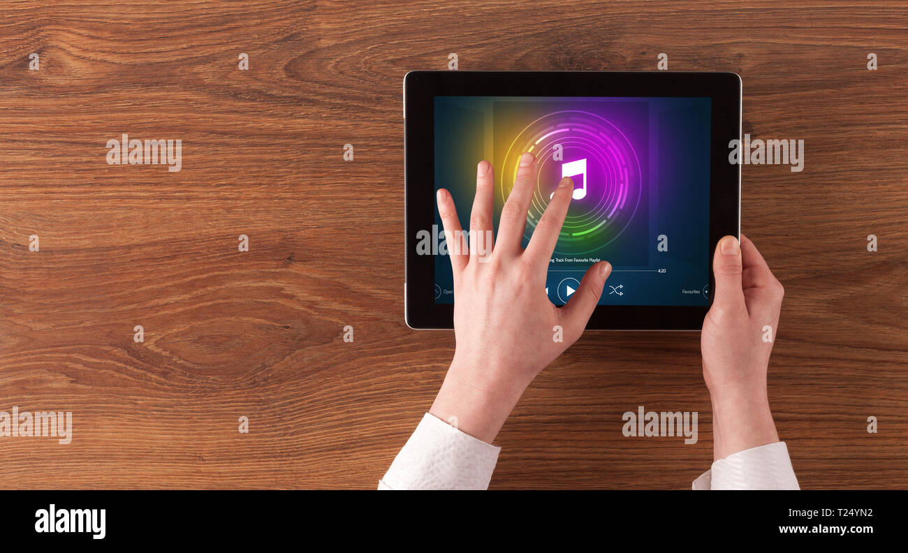 Hand touching tablet with music play concept Stock Photo - Alamy