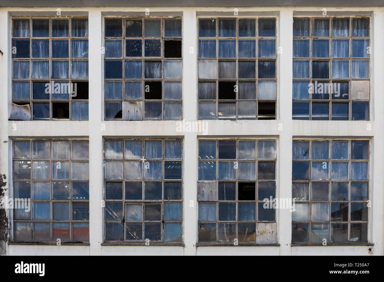 Broken windows at an abandoned building Stock Photo - Alamy
