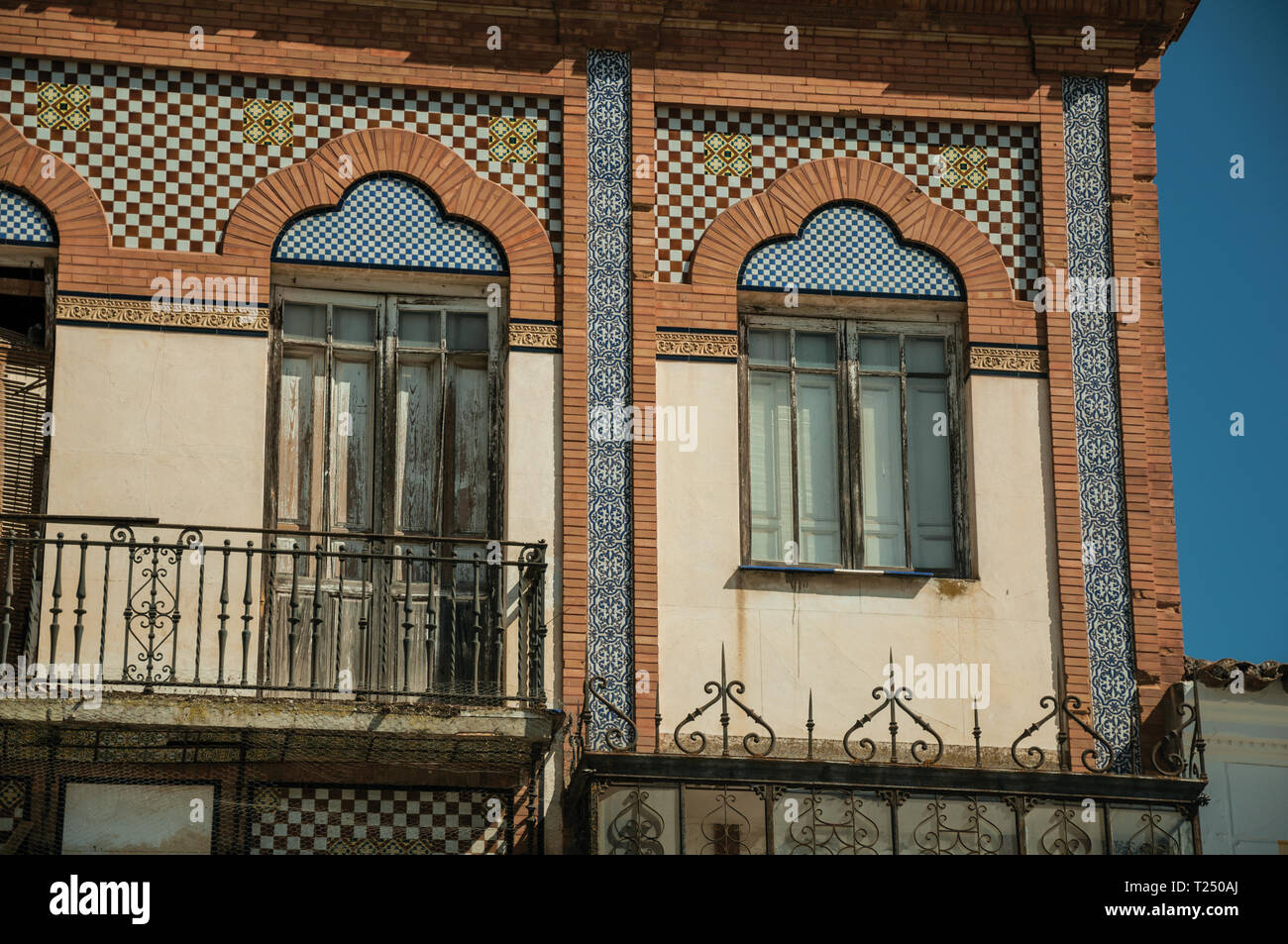 Doors to balcony on building facade in eclectic style with ceramics ...