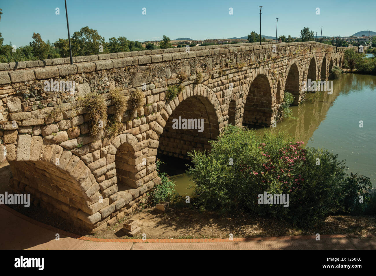 The Puente Romano, an ancient long bridge over the Guadiana River at ...