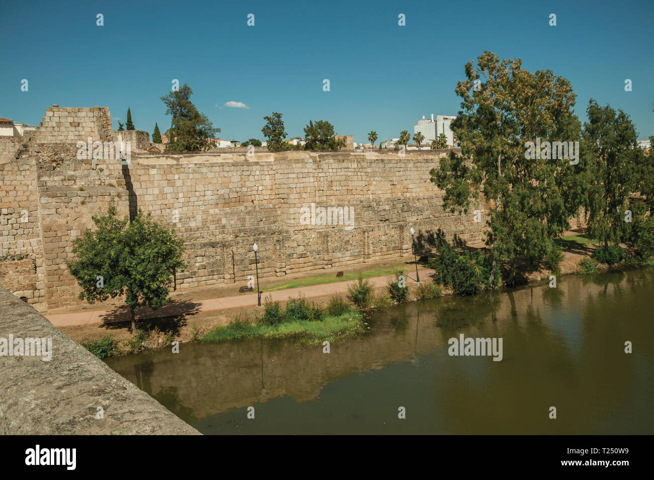 Stone wall from the Alcazaba fortification and pathway next to Guadiana ...