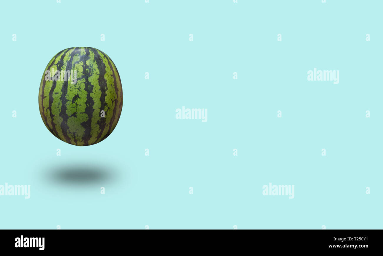 Watermelon isolated on a blue pastel background with a shadow ...