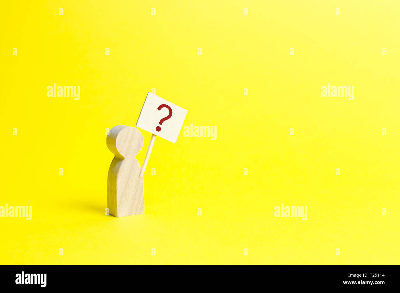 Wooden human figurine with a question mark. Minimalism. Asking a ...