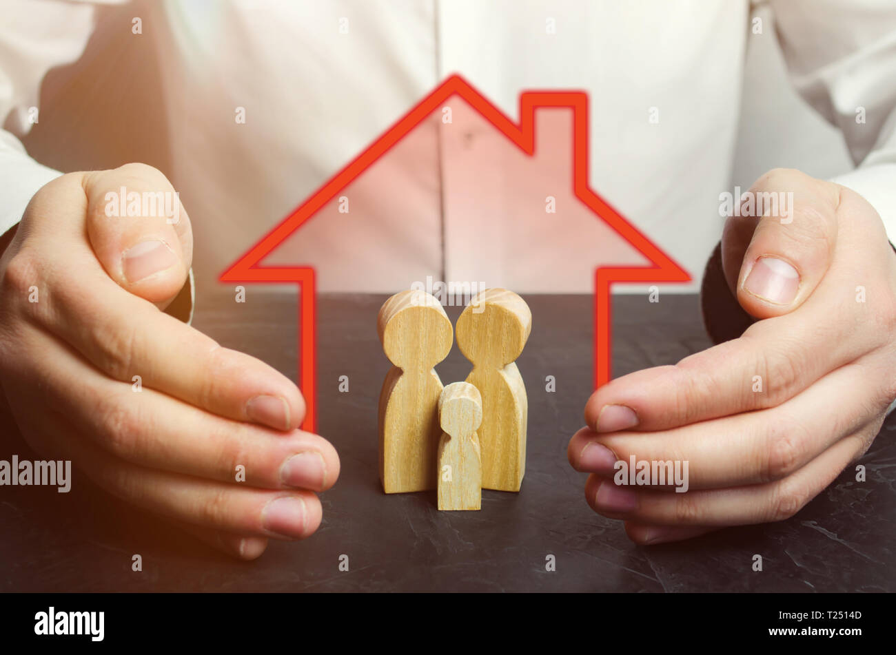 Insurance agent holds hands over family. Family care and helping hand ...