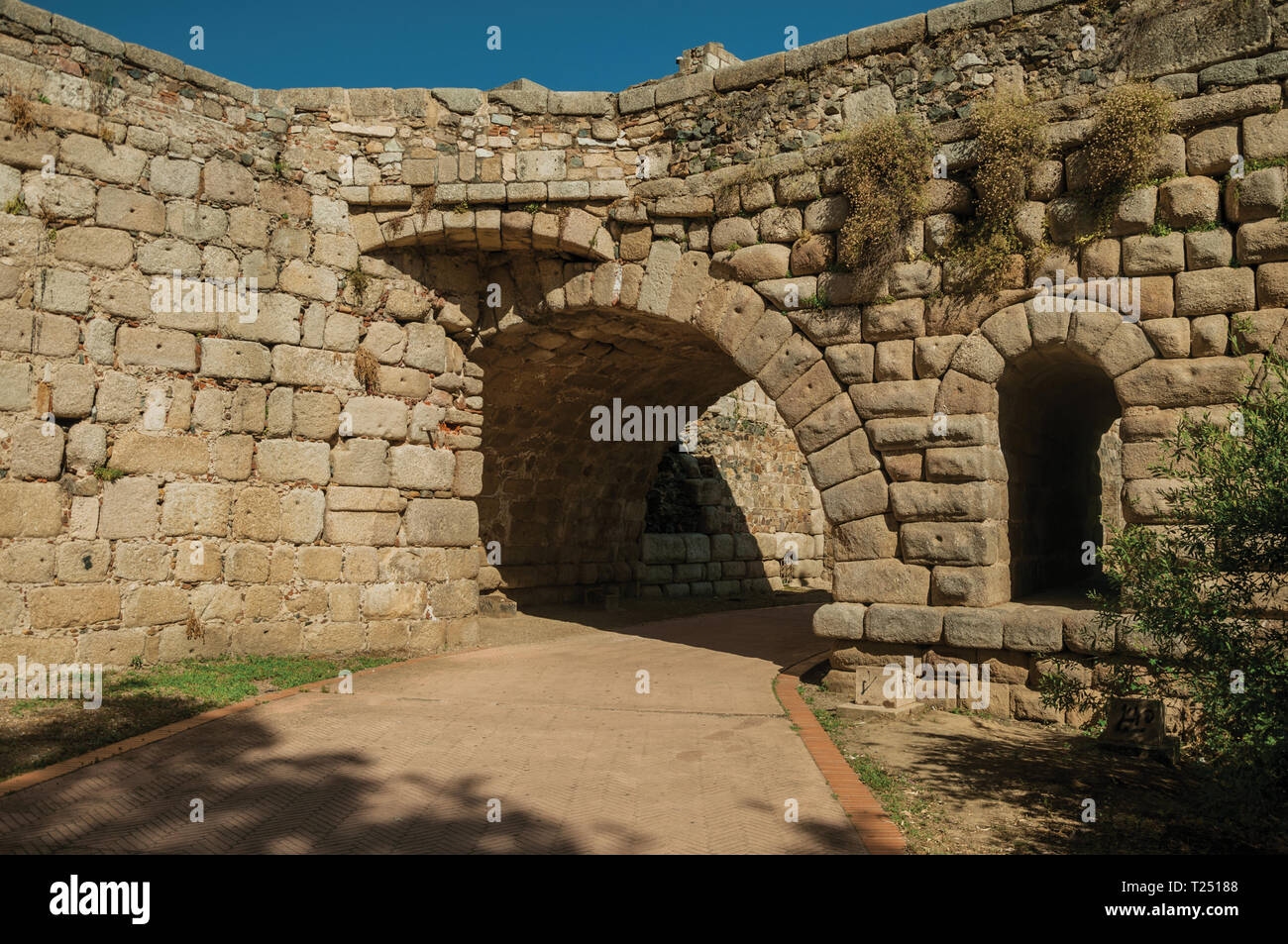 Pathway under stone arch on the Puente Romano over the Guadiana River ...