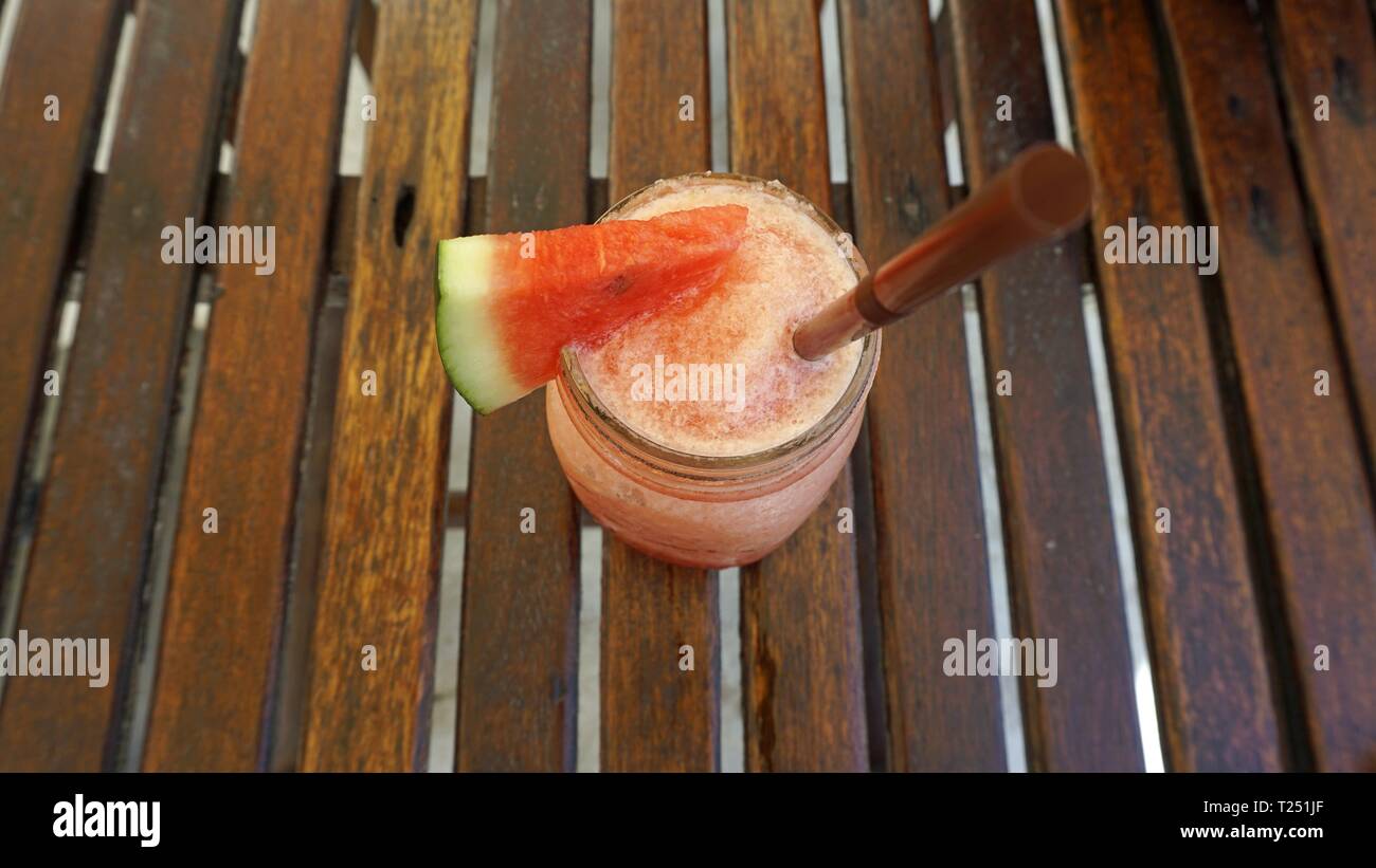 fresh fruit shake with straw in a glass Stock Photo - Alamy