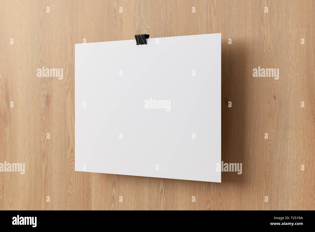 Blank horizontal paper poster hanging on binder clip on wooden wall ...