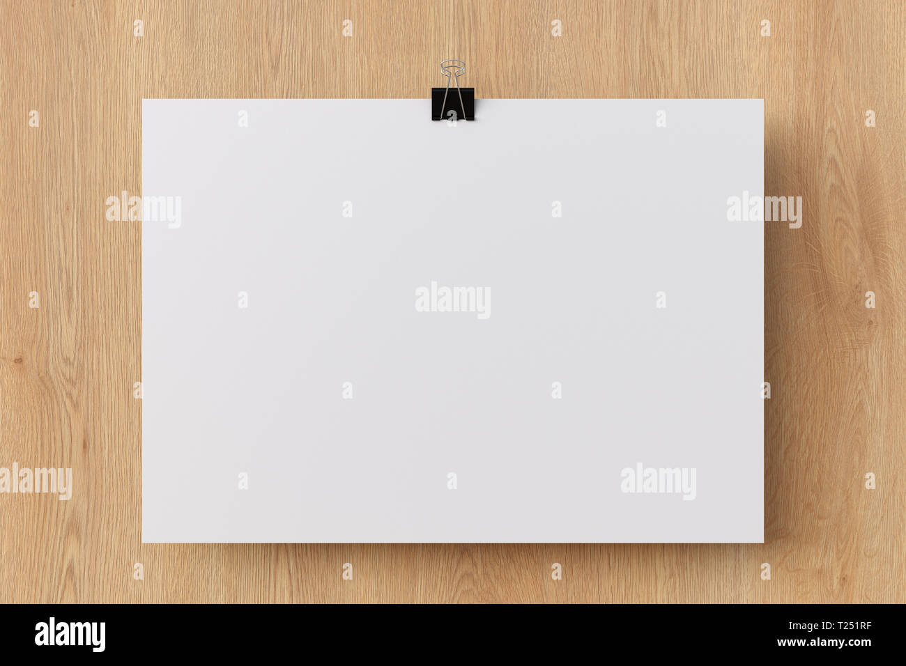 Blank horizontal paper poster hanging on binder clip on wooden wall ...
