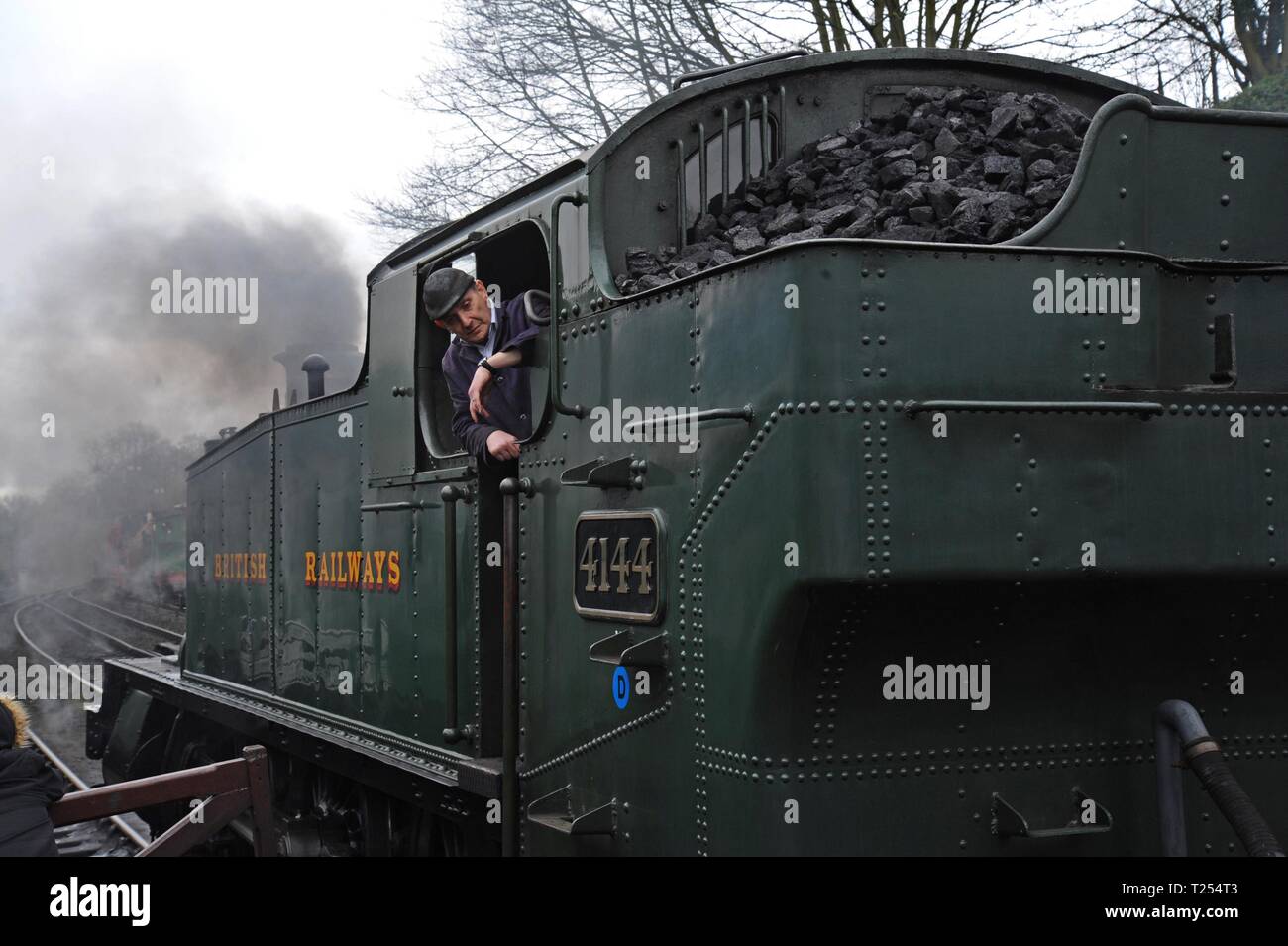 Great Western Railway steam locomotive 4144 driver looks out of the cab ...