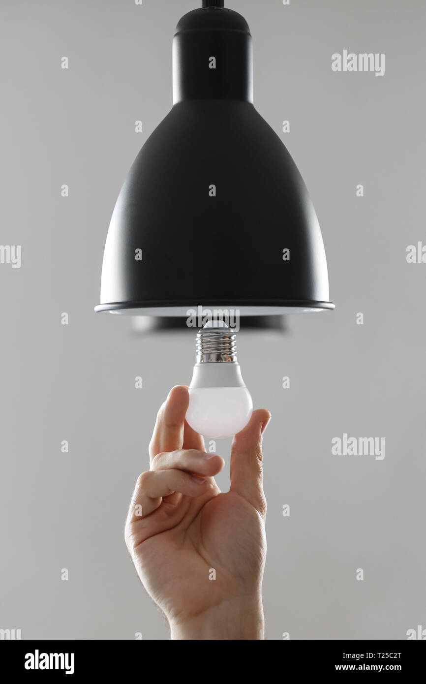 Changing the bulb for led bulb in floor lamp in black colour. On light ...