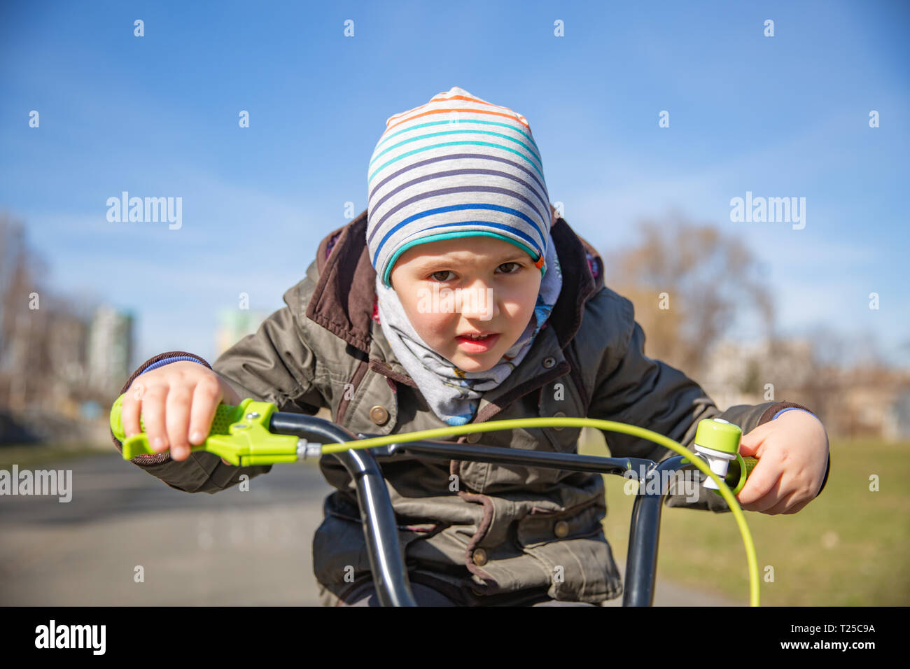 Little child boy on bicycle in park outdoor. A child is riding a ...
