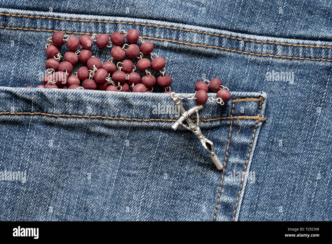 Catholic rosary in the back pocket of the denim jeans Stock Photo - Alamy
