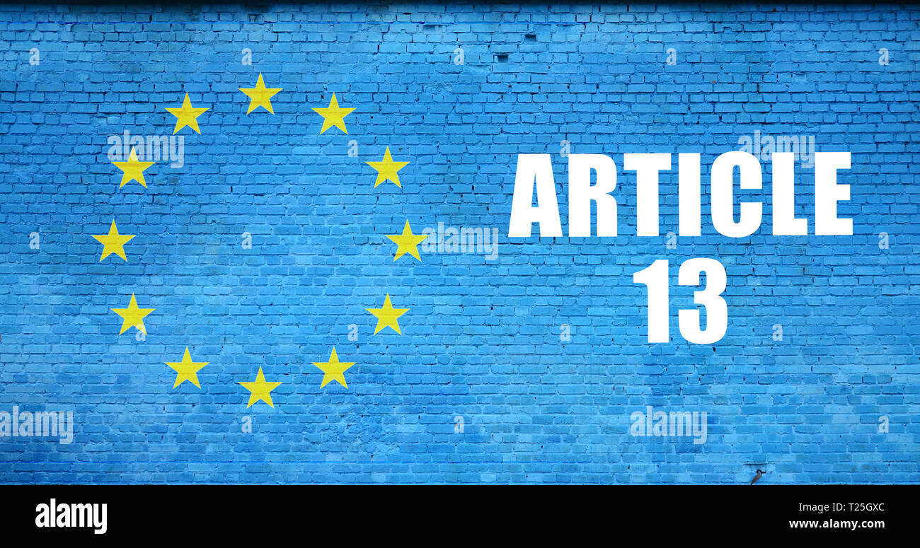 Article 13 inscription and european union flag on blue brick wall ...