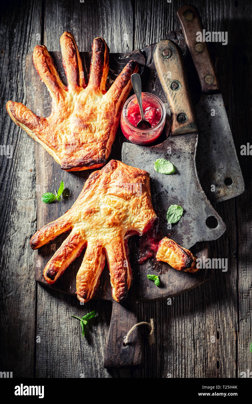 Strange hand cake with a chopper as concept of liking Stock Photo - Alamy