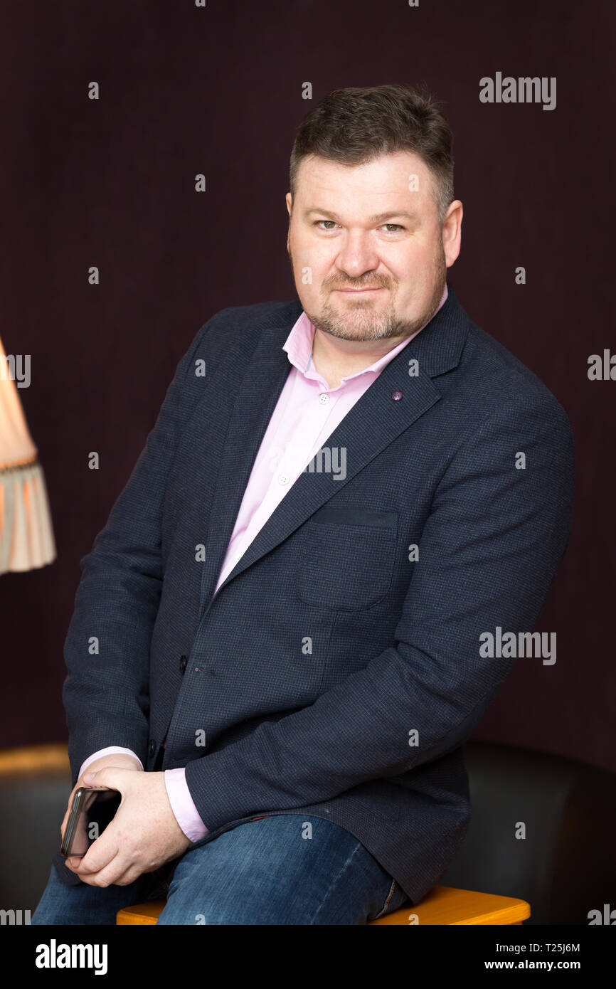 Solid fat man with a beard on his face with a phone in his hands Stock ...
