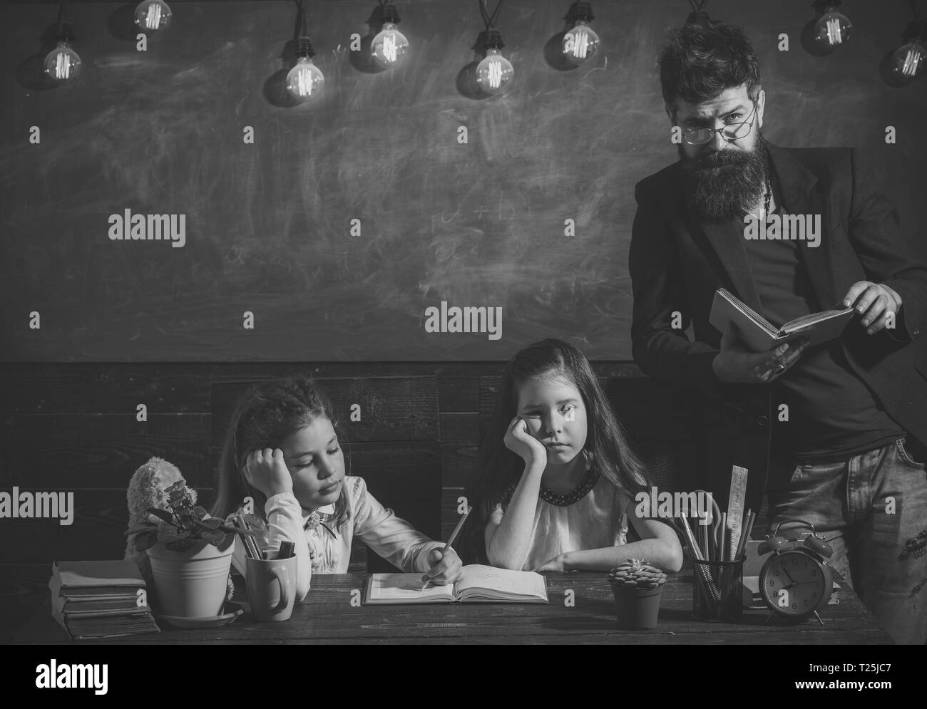 Boring lesson concept. Teacher and girls pupils in classroom ...