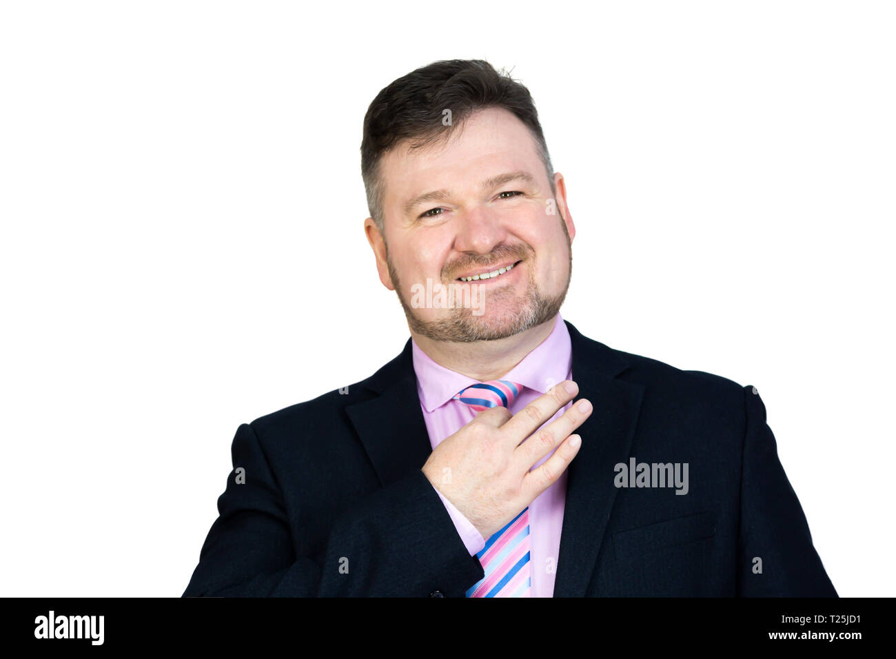 A fat middle-aged man with a beard straightens his tie around his neck ...