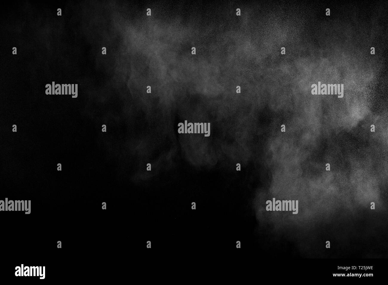 Abstract white powder explosion against black background.White dust ...