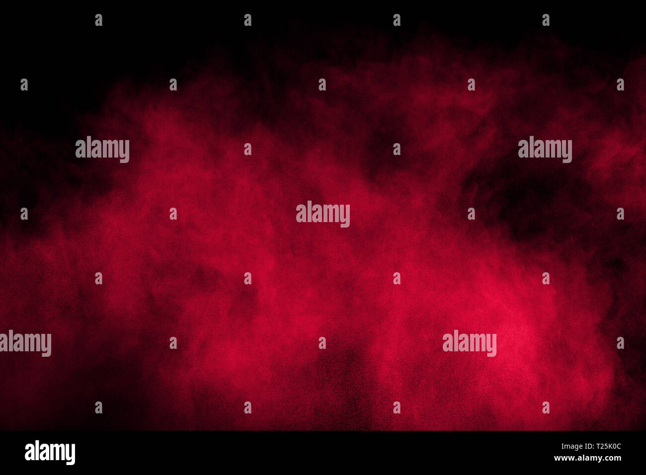 Red color powder explosion on black background.Freeze motion of red ...