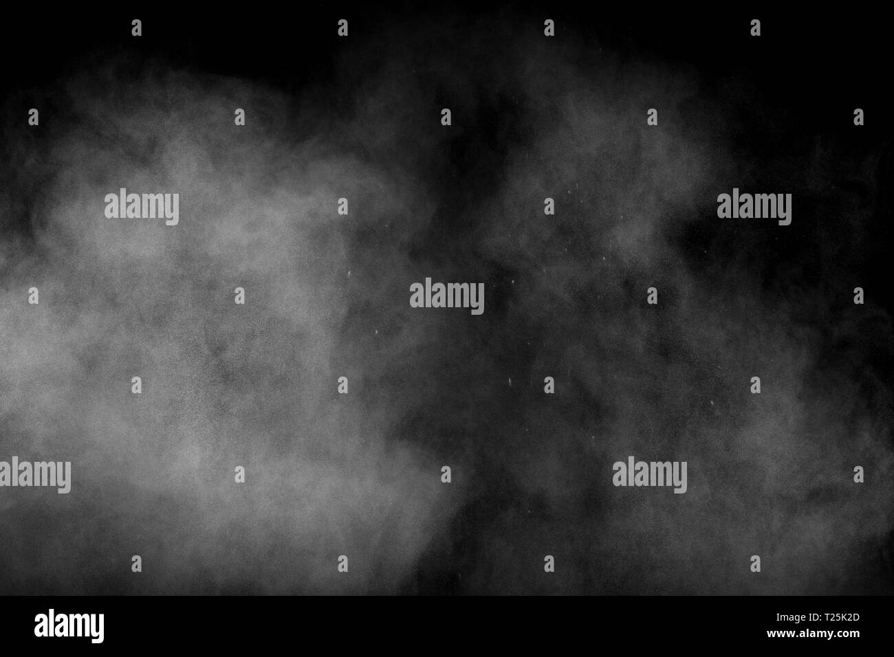 Abstract white powder explosion against black background.White dust ...