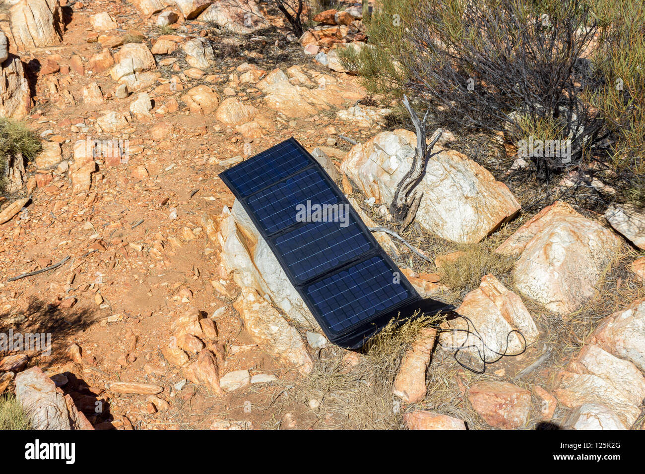 solar panel in campsite on a rock to charge phones and camera ...