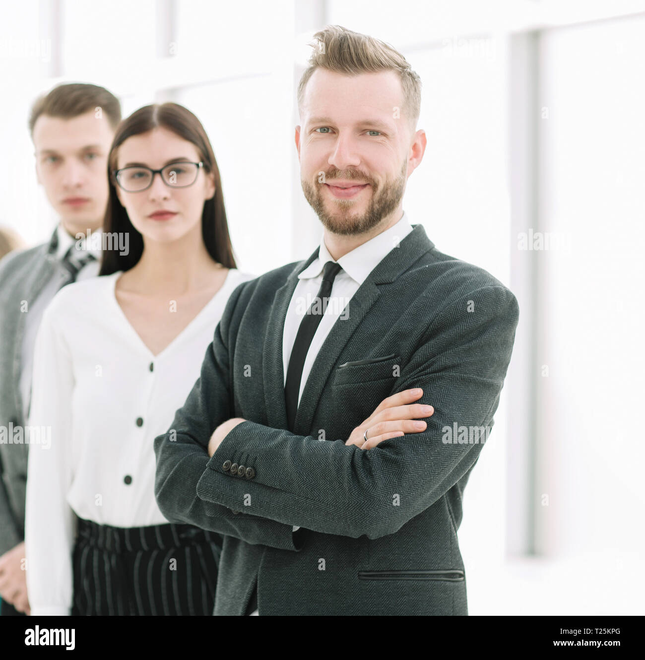 portrait of a businessman and his business team standing in the office ...