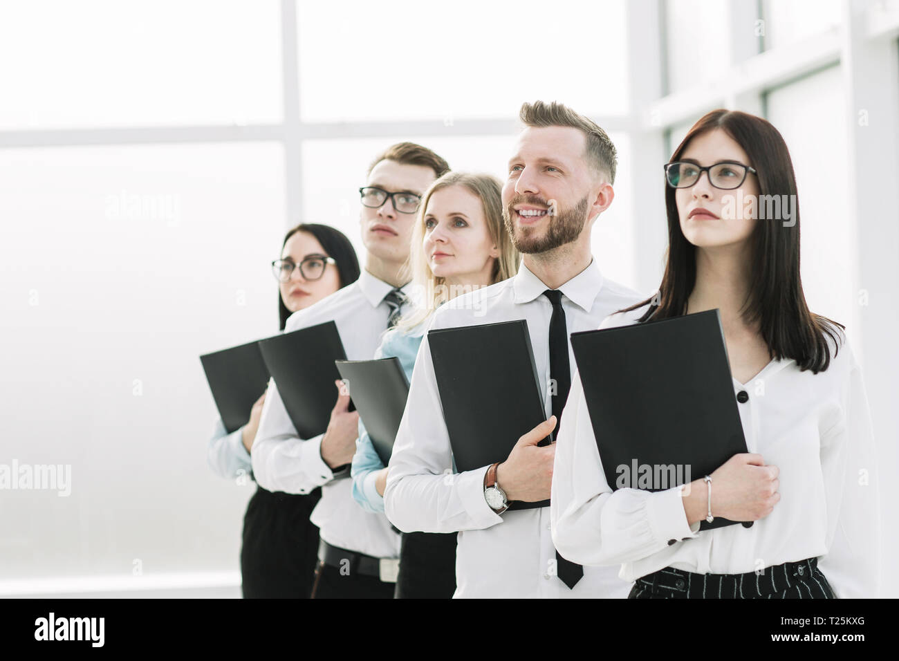 close up.a group of young employees standing in line for an interview ...