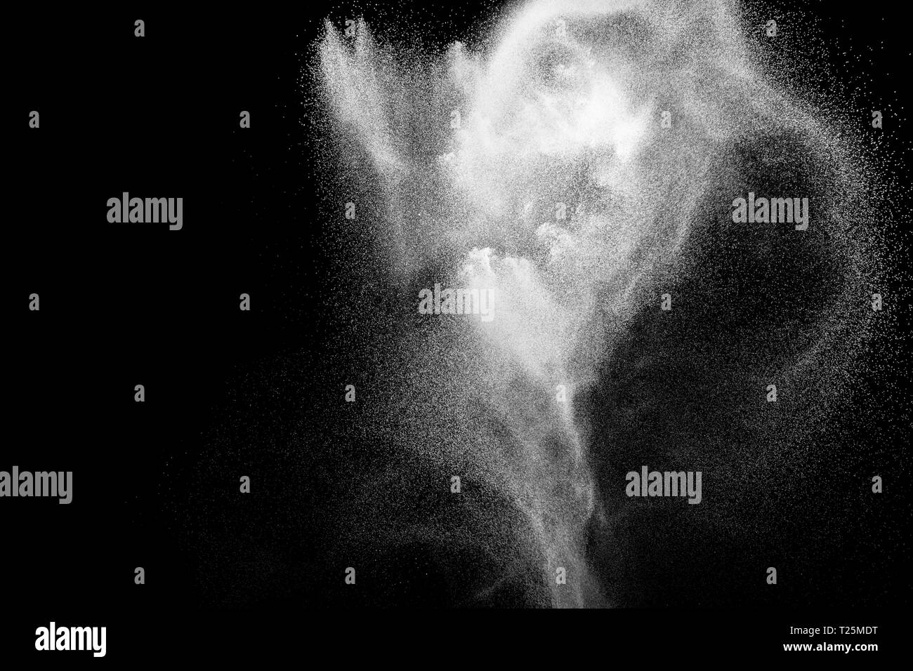 White powder explosion.Freeze motion of white dust particles on black ...