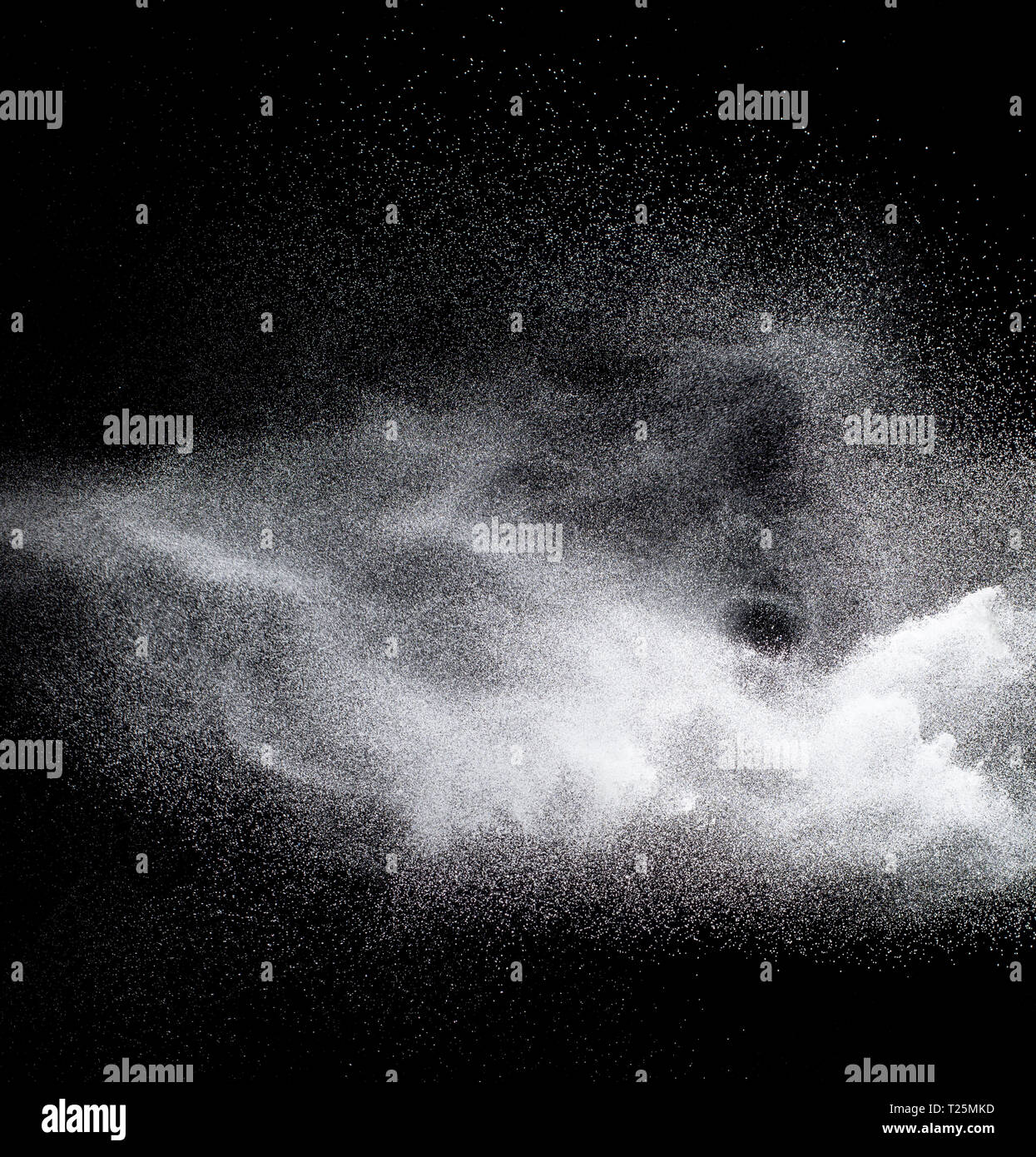 White powder explosion.Freeze motion of white dust particles on black ...