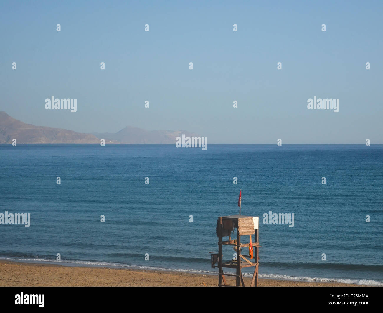 Old broken wooden lifeguard tower on an abandoned beach in the early ...