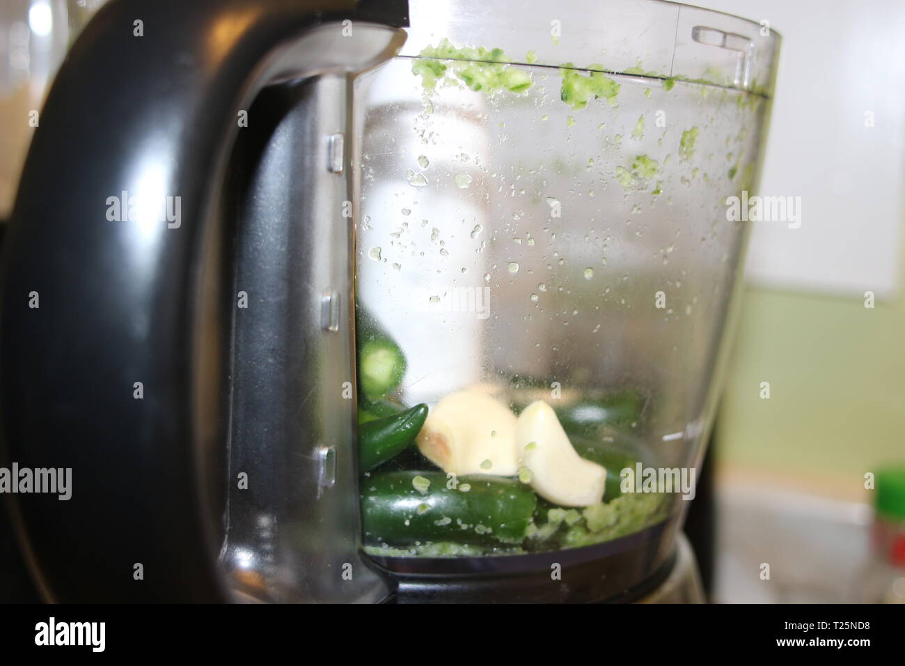 Making red hot chili pepper mash in a grinder. Hot sauce production ...