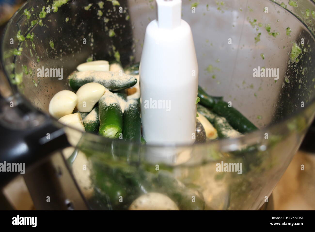 Making red hot chili pepper mash in a grinder. Hot sauce production ...