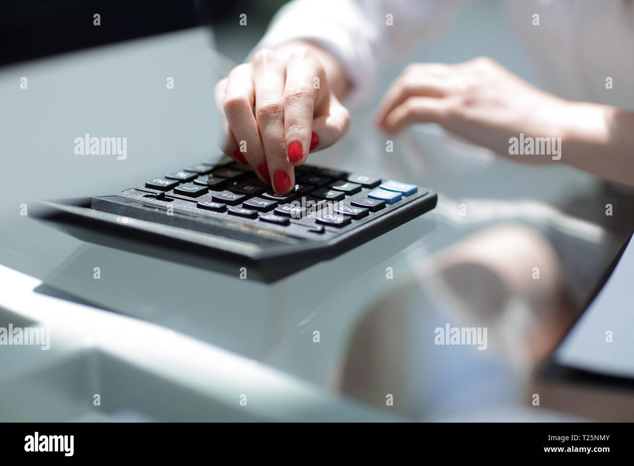 .closeup.business woman using a calculator at the workplace Stock Photo ...