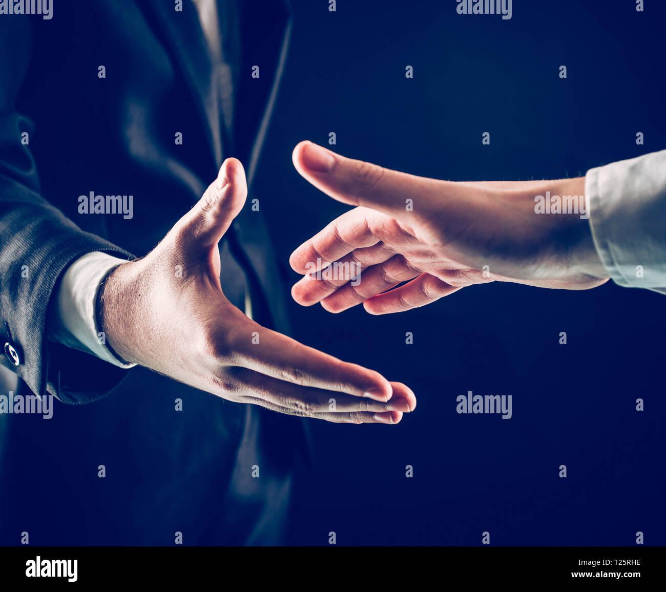 closeup of two businessmen stretches his hand forward for a handshake ...