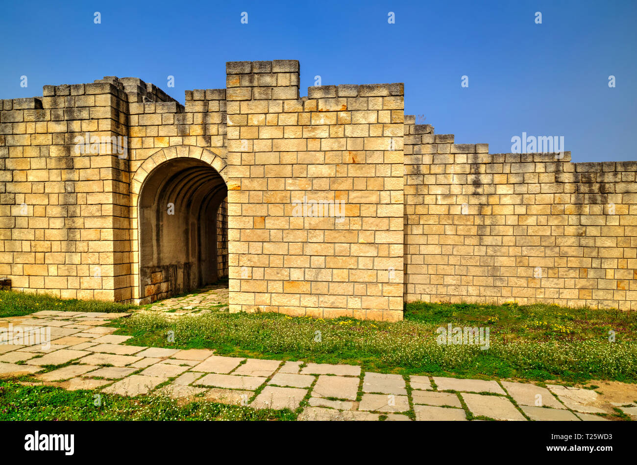 Solid stone wall and entrance of ancient fortress Stock Photo - Alamy