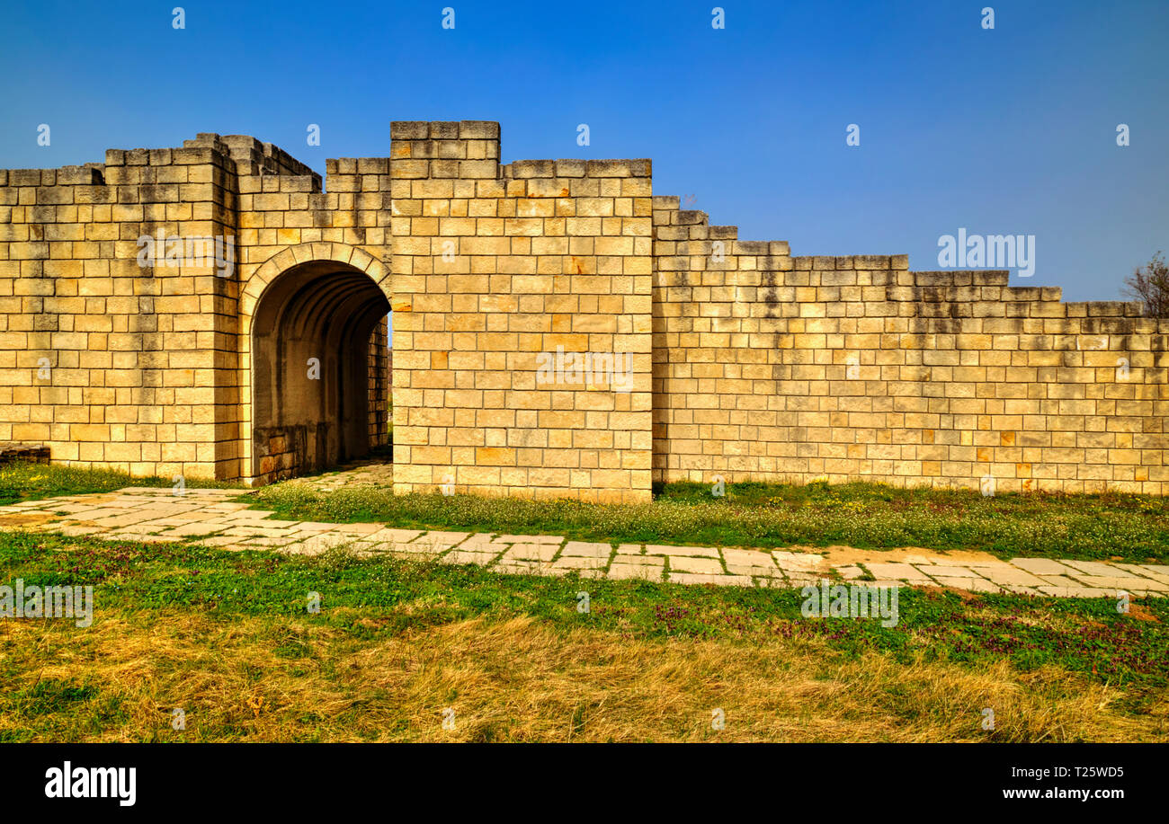 Solid stone wall and entrance of ancient fortress Stock Photo - Alamy