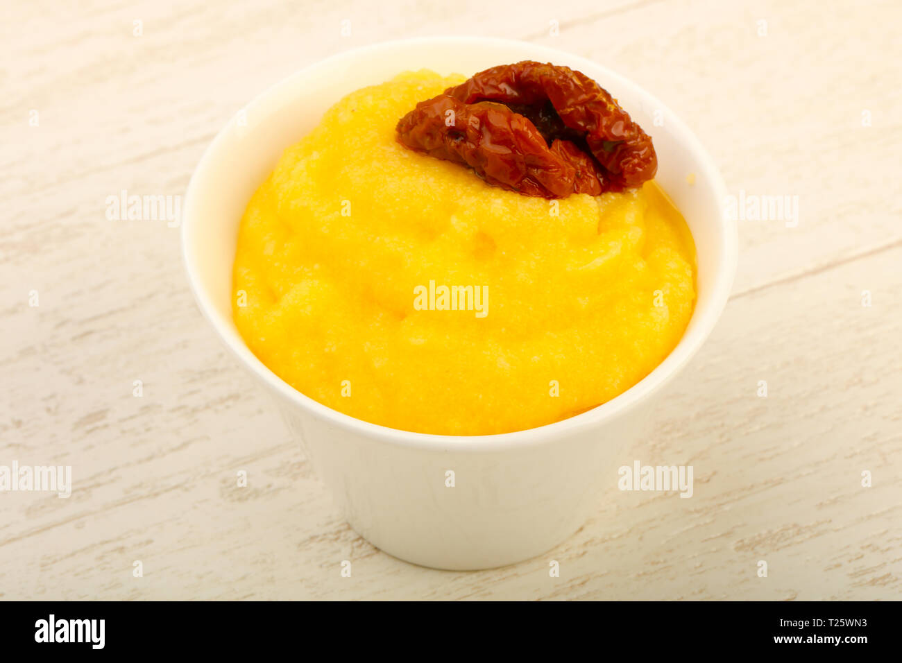 Polenta with dry tomato Stock Photo - Alamy