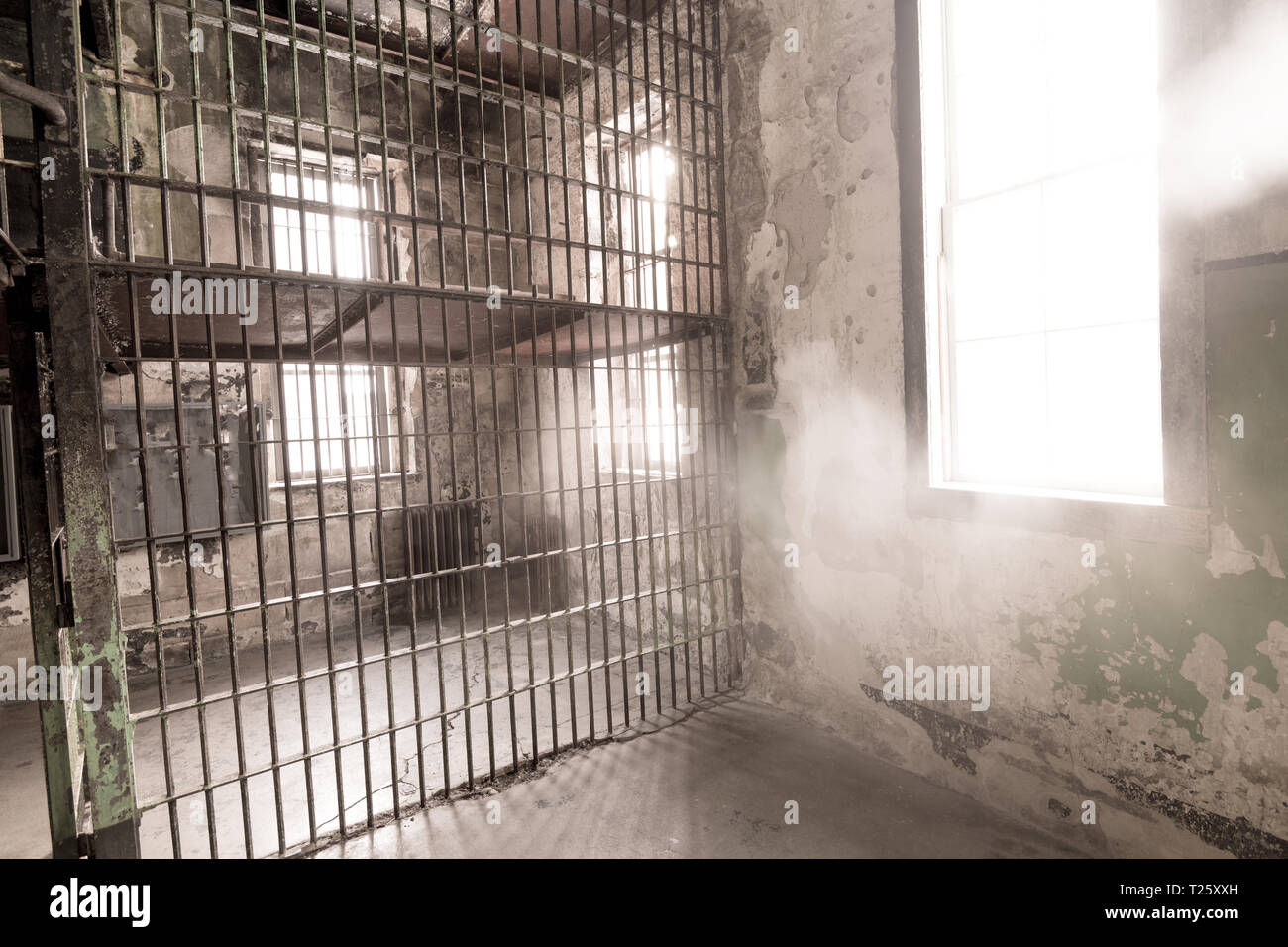 Smoke illuminating in front of windows in a prison Stock Photo - Alamy