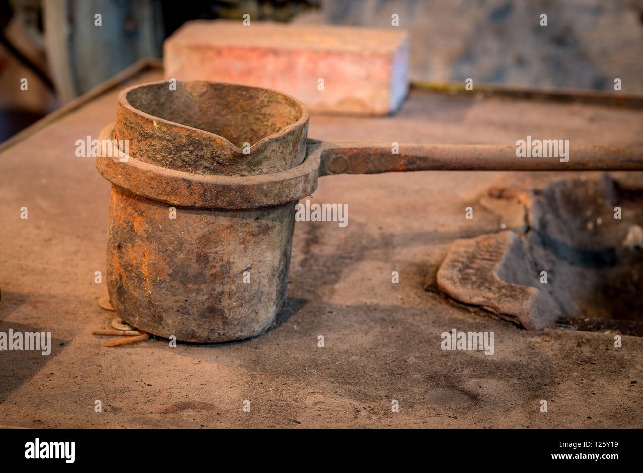 Metal workers molten material pot used for making tools Stock Photo - Alamy