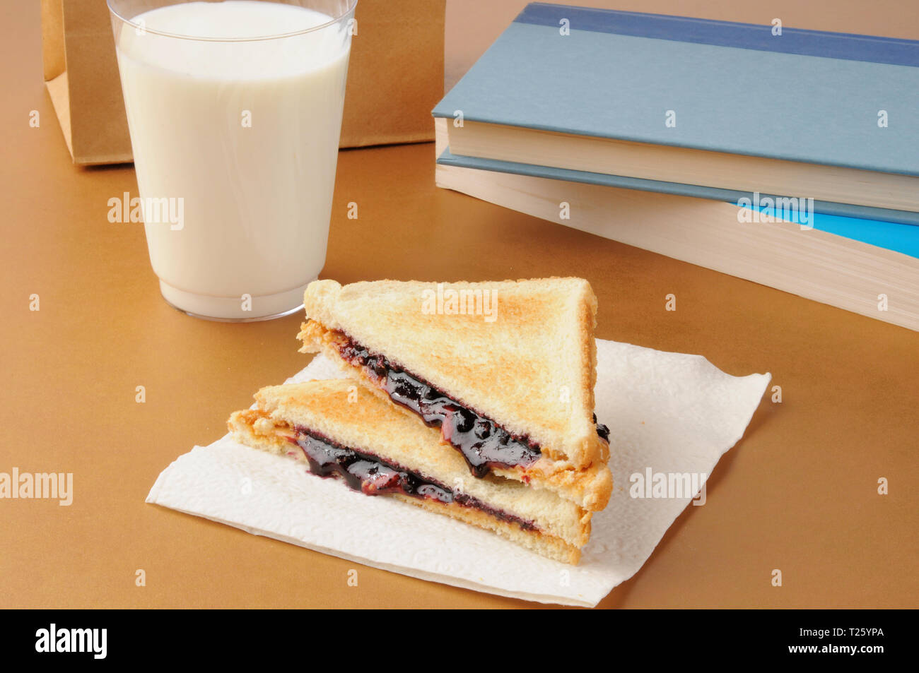 Peanut butter and jelly sandwich with school books Stock Photo - Alamy