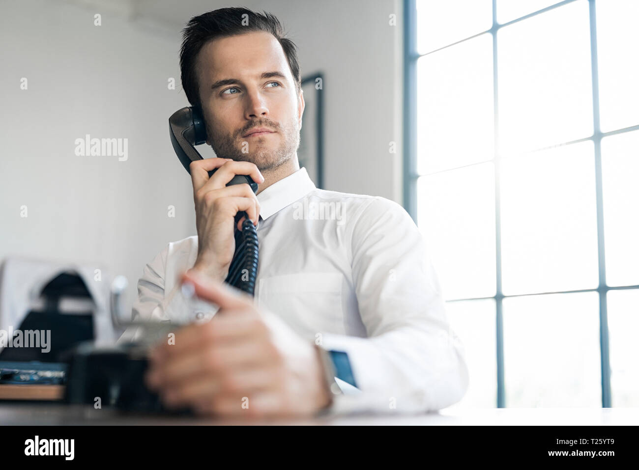 Businessman in office using vintage retro telephone Stock Photo - Alamy