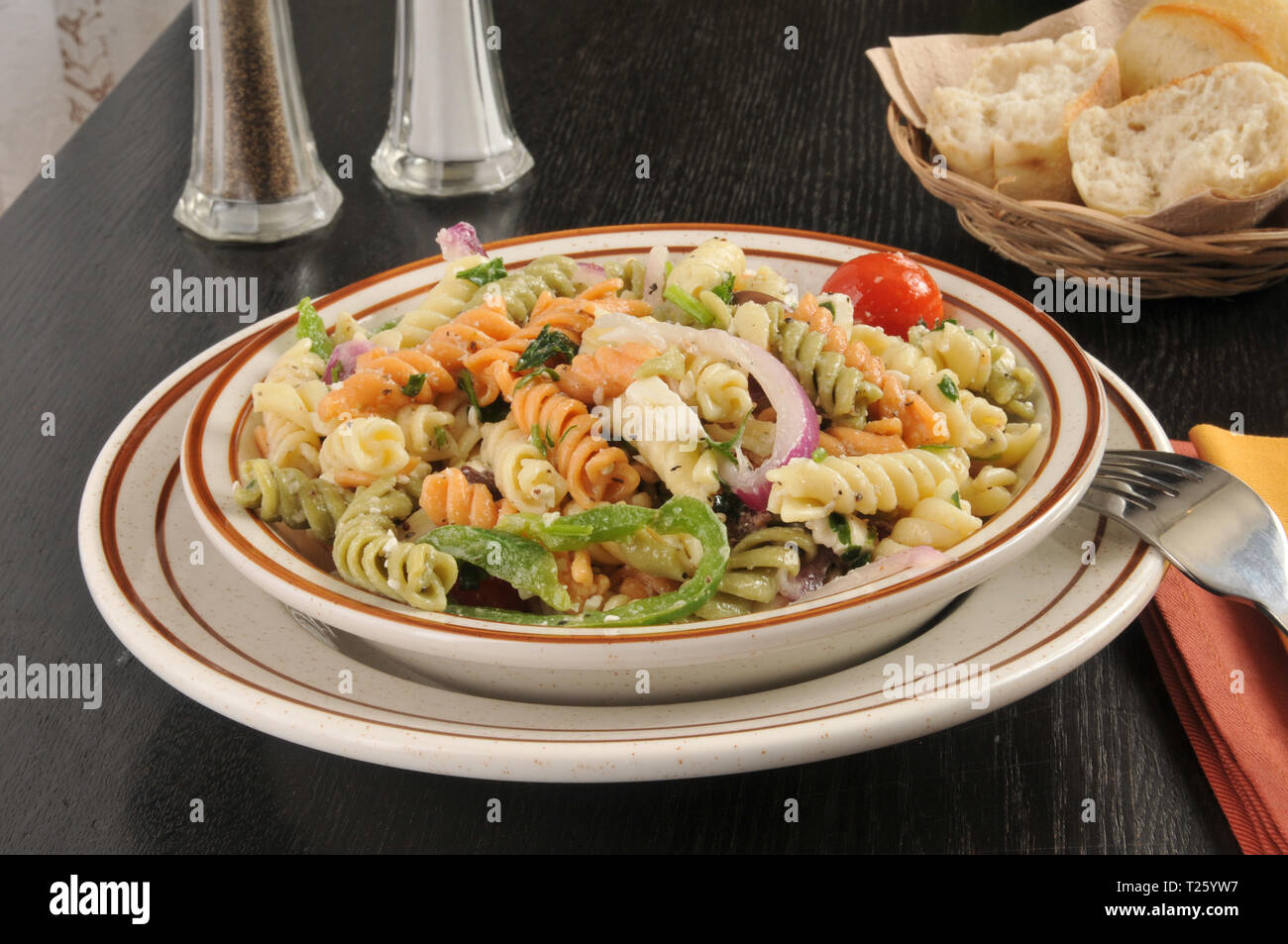 Mediterranean pasta salad with feta cheese and dinner rolls Stock Photo ...